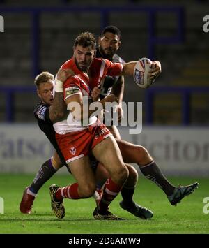 Alex Walmsley of St. Helens is tackled by Ed Chamberlain of Hull FC and ...