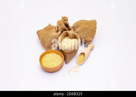 Whole peeled millet grains isolated on white background. A traditional ...