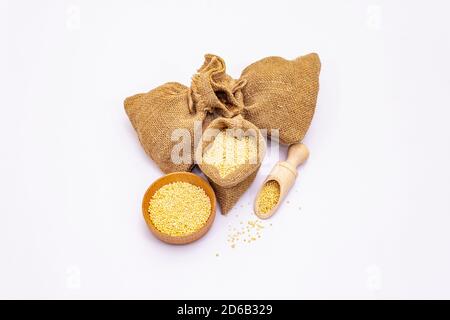 Whole peeled millet grains isolated on white background. A traditional ...