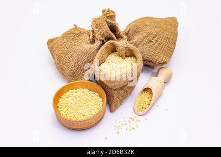Whole peeled millet grains isolated on white background. A traditional ...