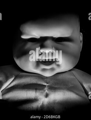 Creepy doll face. It seems like character of horror movie. Angry baby ...