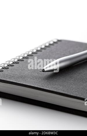 Note book with pen isolated over white background Stock Photo - Alamy
