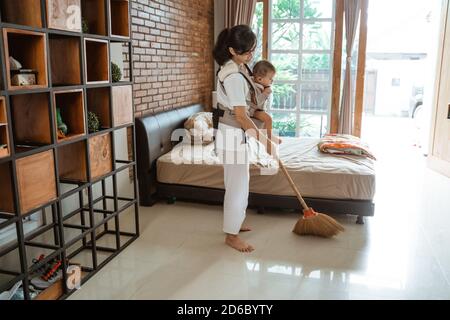 Little cute girl brooming floor at home Stock Photo - Alamy