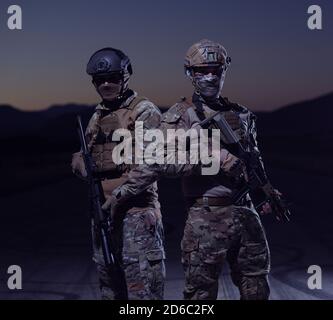 Two heavily armed special forces soldiers in full protective military ...