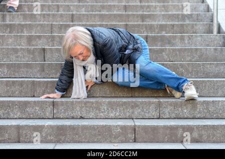 Senior woman accidentaly falling down stone steps outdoors Stock Photo ...