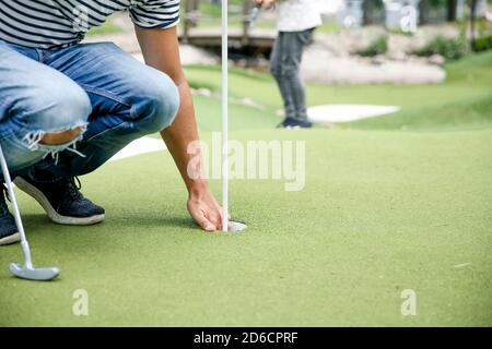 Close-up of miniature golf hole with bat and ball Stock Photo - Alamy