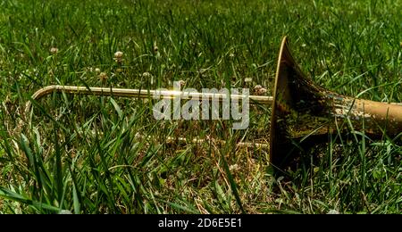 Old rusty trombone lays in grass field at music festival Stock Photo ...