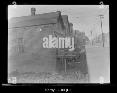 A black and white photograph showing an unidentified woman driving a ...