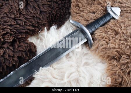 Viking Age sword on sheep fur background Stock Photo - Alamy