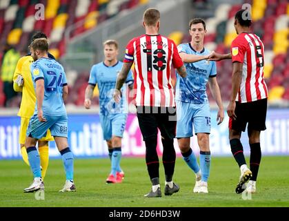 Brentford's Ethan Pinnock (second right) scores an own goal to make the ...