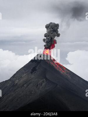 Glowing lava and smoke spitting volcano, volcanic eruption, Volcan de ...