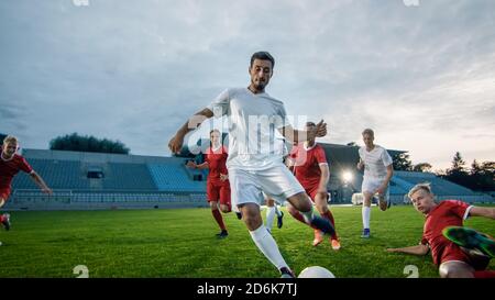 Professional sportsman playing football at stadium Stock Photo - Alamy