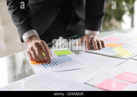 Analyzing data. Close-up of young businessman pointing on the data ...