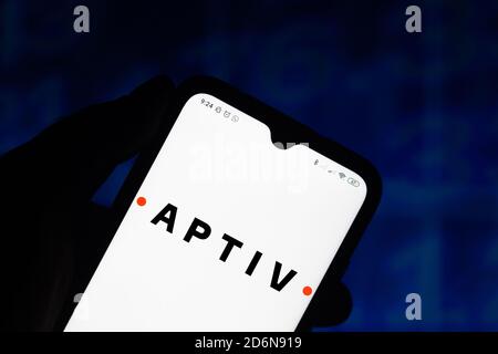 In this photo illustration, the Aptiv logo is seen displayed on a ...