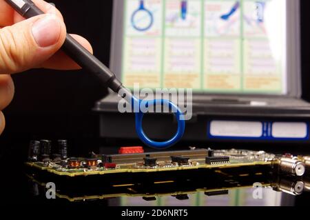 Electromagnetic compatibility (EMC) engineer holding magnetic near ...