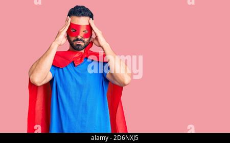 Sad suffering superhero with strong headache touching his head Stock ...