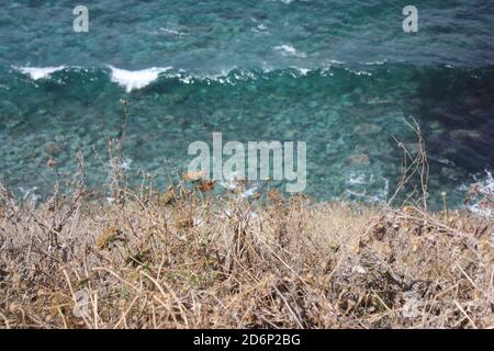 Aerial shot of a cliffy shore near the wavy sea at daytime Stock Photo ...