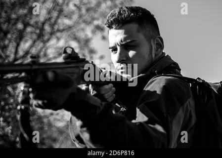 Hunter with Powerful Rifle with Scope Spotting Animals. Hunter with ...