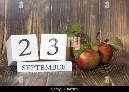 Cube calendar with date 1 SEPTEMBER, apple and school books on table in ...
