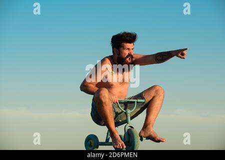 Crazy man riding a small bicycle. Funny bicycle rider. Comic man ride ...
