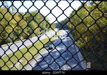 metal chain link fence over highway or road with cars Stock Photo - Alamy