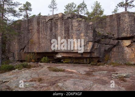 View of a cave among amazing rock formations. Huge block on a rocky ...