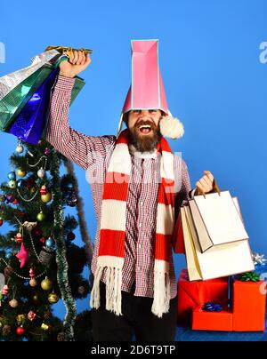 Guy with pink packet on head holding shopping bags Stock Photo - Alamy