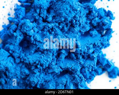 Closeup view of blue pigment. Pigment powder detail. Powders on white ...