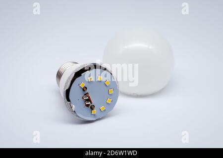 disassembled led household lamp with a burnt led element is on the ...