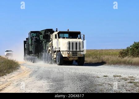 A Rough Terrain Container Handler (RTCH) loads a container onto a ...