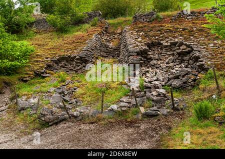 Tapering cylindrical structure, possibly an old lime kiln, adjacent to ...