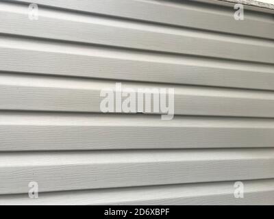 Exterior Vinyl Siding Damaged By Hail, Wind, Hailstorm Stock Photo - Alamy
