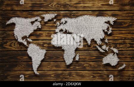 Top view world map on a brown wooden table Stock Photo - Alamy
