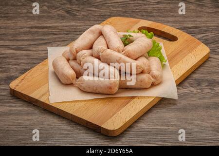 Raw natural chicken baby sausages for roast Stock Photo - Alamy
