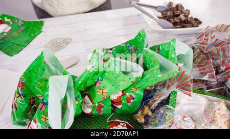 Step by step. Packaging homemade fudge and cookies into a Christmas ...