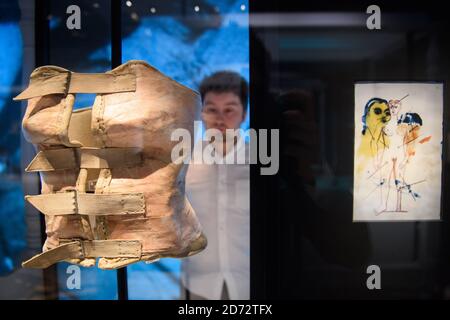 Visitors look at medical corsets owned by Frida Kahlo, part of the ...