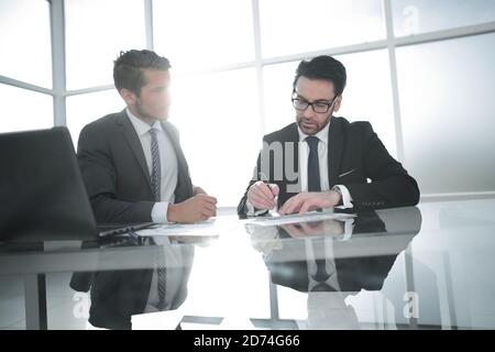Two businessmen discuss financial documents Stock Photo - Alamy