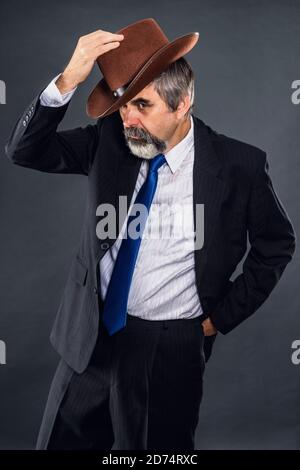 Man with beard in hat puts toy on fir tree Stock Photo - Alamy