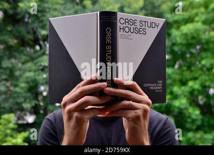 Man reading 'Case Study Houses' book Stock Photo - Alamy