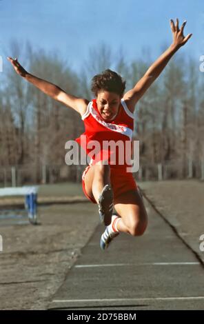 Female track and field long jumper landing in sand Stock Photo - Alamy