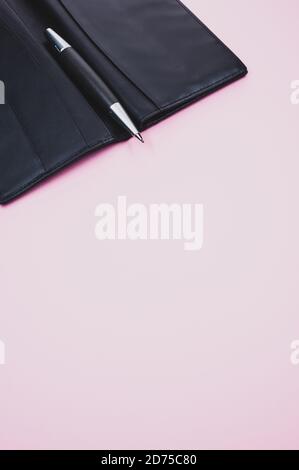 Closeup of a rollerball pen on a small leather wallet isolated on a ...