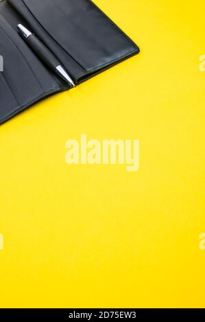 Closeup of a rollerball pen inside a small leather wallet isolated on a ...