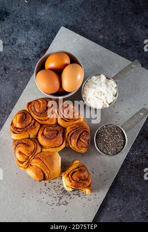 sweet pastries, roll with poppy seeds inside on a white background ...