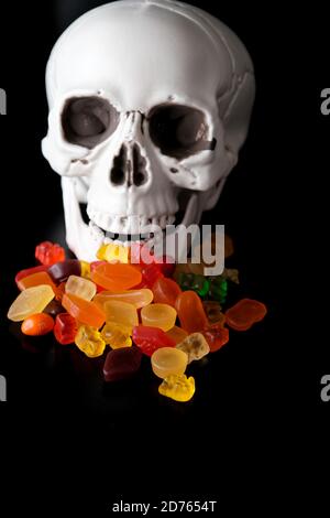 Skeleton Skull with Candy to eat during Halloween Stock Photo - Alamy
