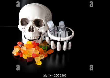 Skeleton Skull with Candy to eat during Halloween Stock Photo - Alamy