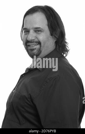 smiling overweight man looking at camera while working out with pink ...