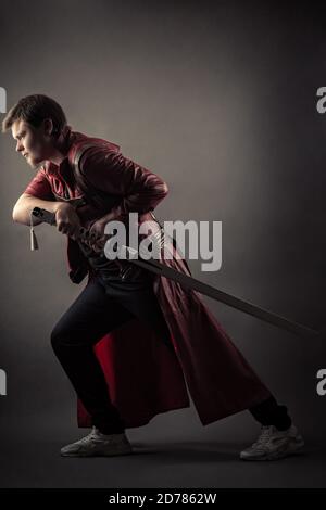 Warrior man posing with a sword isolated on black background Stock ...