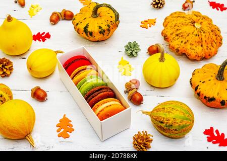 French macarons in autumn colors with hot tea. Halloween dessert ...