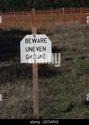 Sign warning of uneven ground Stock Photo - Alamy