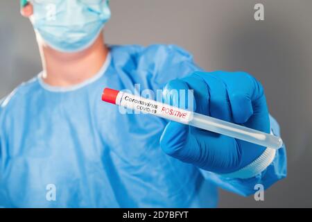 Virologist holding coronavirus swab test sample in a vial with gloves ...